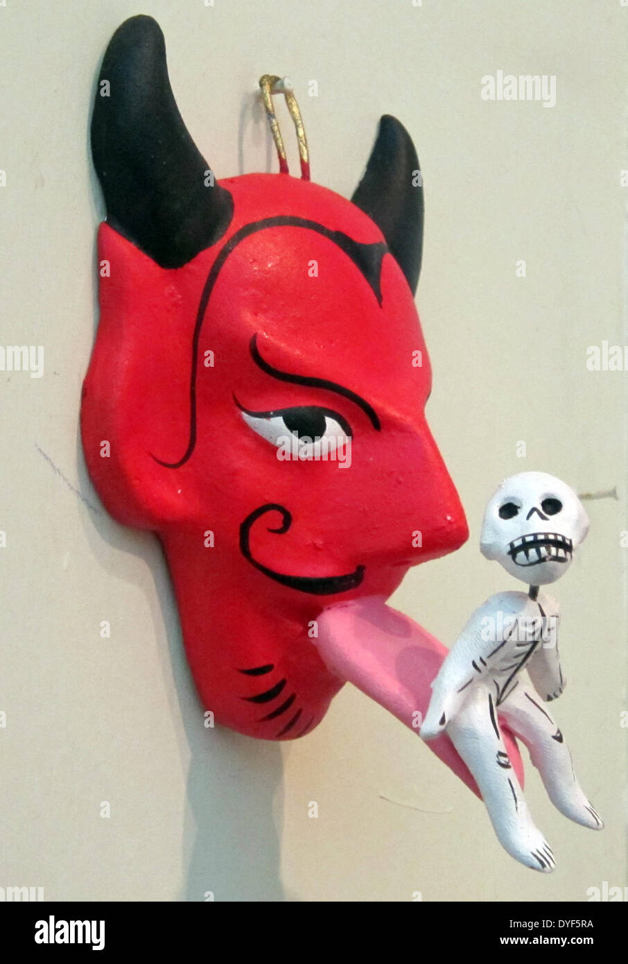 Mexican Red Devil mask with skeleton sitting on his protruded tongue ...