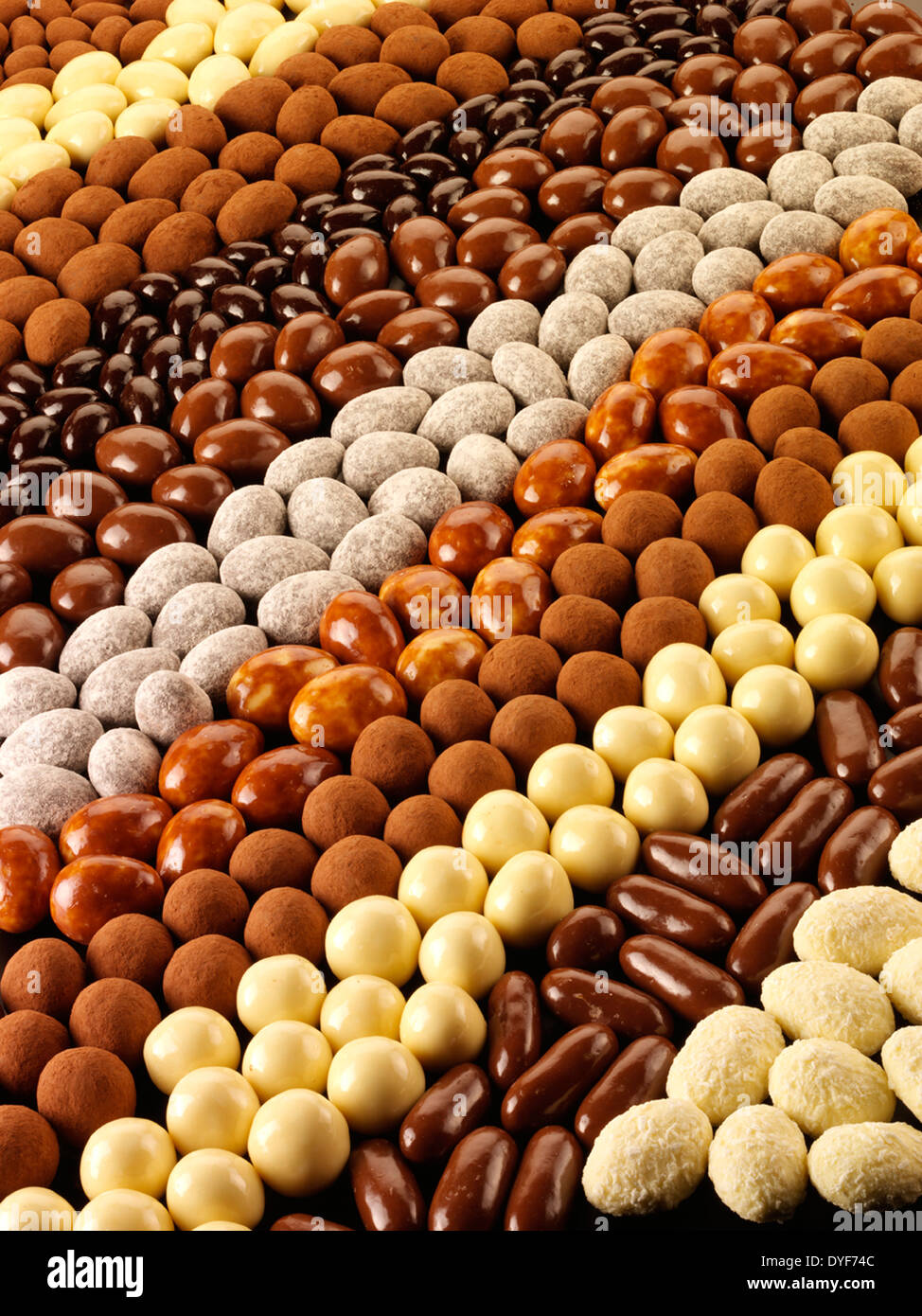 ASSORTED COATED NUTS ARRANGED IN LINES Stock Photo - Alamy