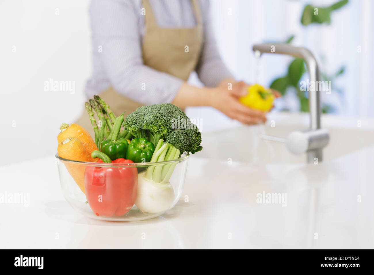 Woman washing vegetables in the kitchen Stock Photo - Alamy