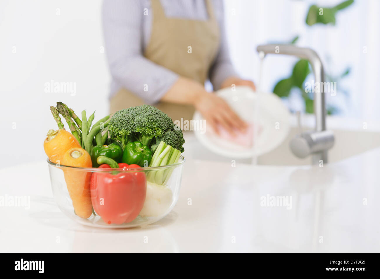 Woman washing dishes in the kitchen Stock Photo - Alamy