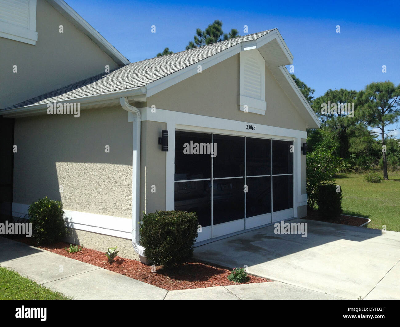 Florida home with sliding garage screens allowing air to circulate ...