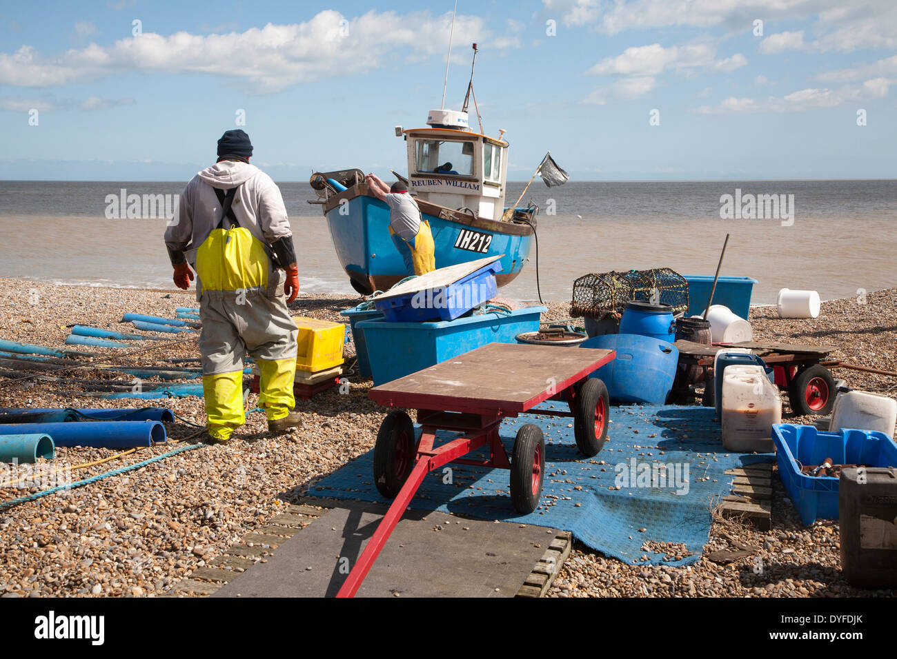 Small inshore fishing boat landing on the beach after six hours at sea ...