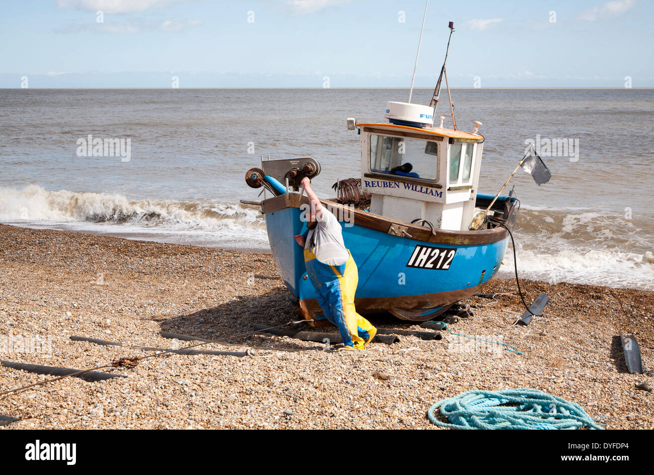 Small inshore fishing boat landing on the beach after six hours at sea ...