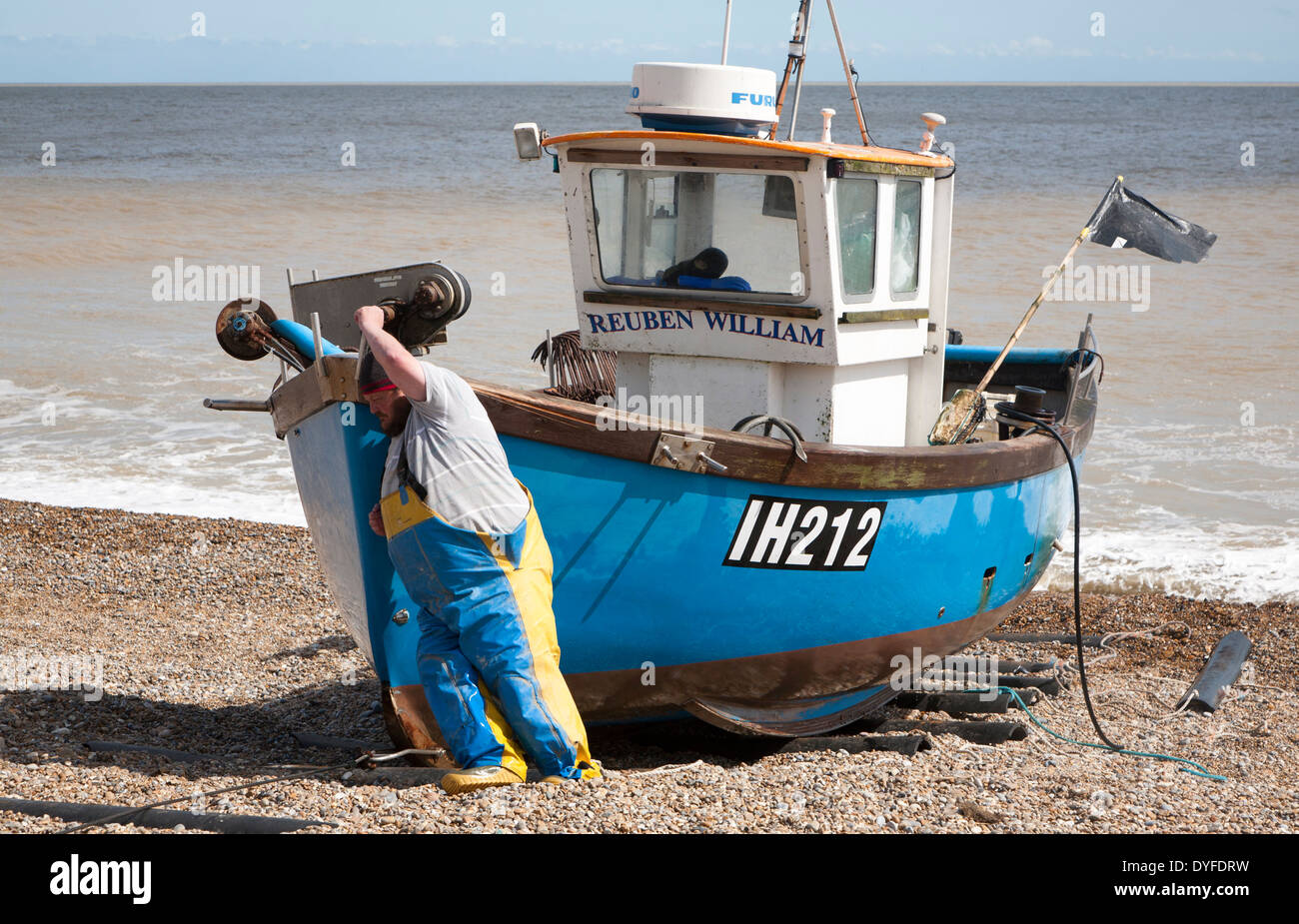Small inshore fishing boat landing on the beach after six hours at sea ...
