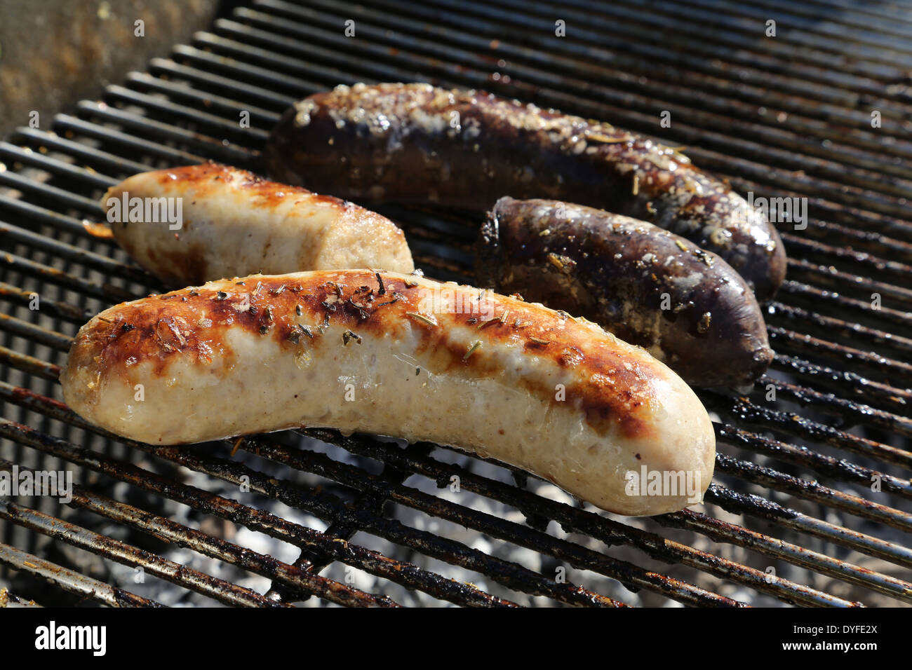Cooking a Meat on a Barbecue outside in the garden Stock Photo - Alamy