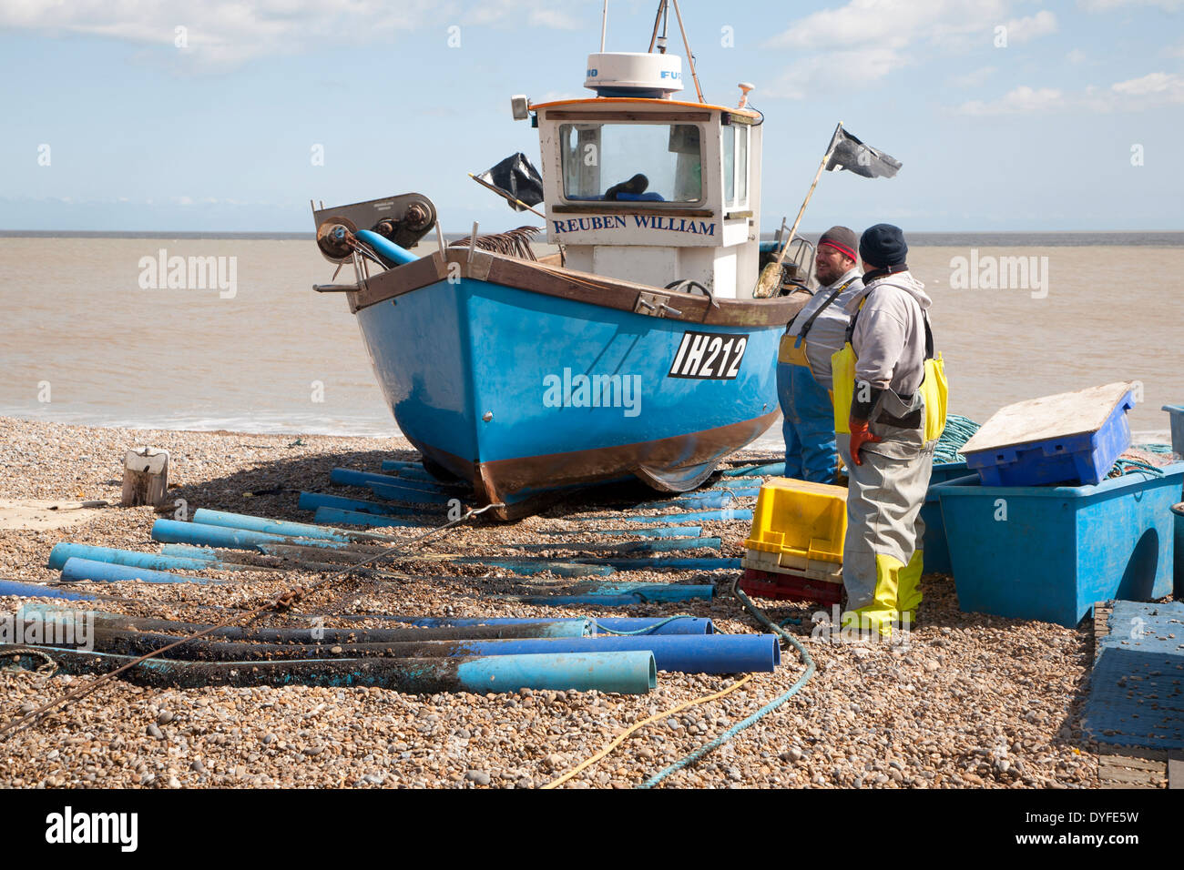 Small inshore fishing boat landing on the beach after six hours at sea ...