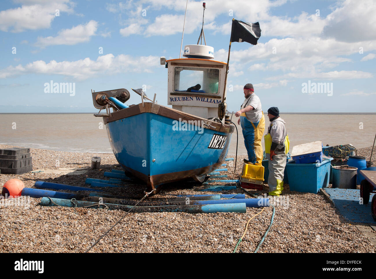 Small inshore fishing boat landing on the beach after six hours at sea ...
