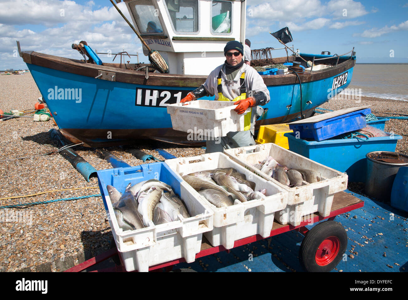 Small inshore fishing boat landing on the beach after six hours at sea ...