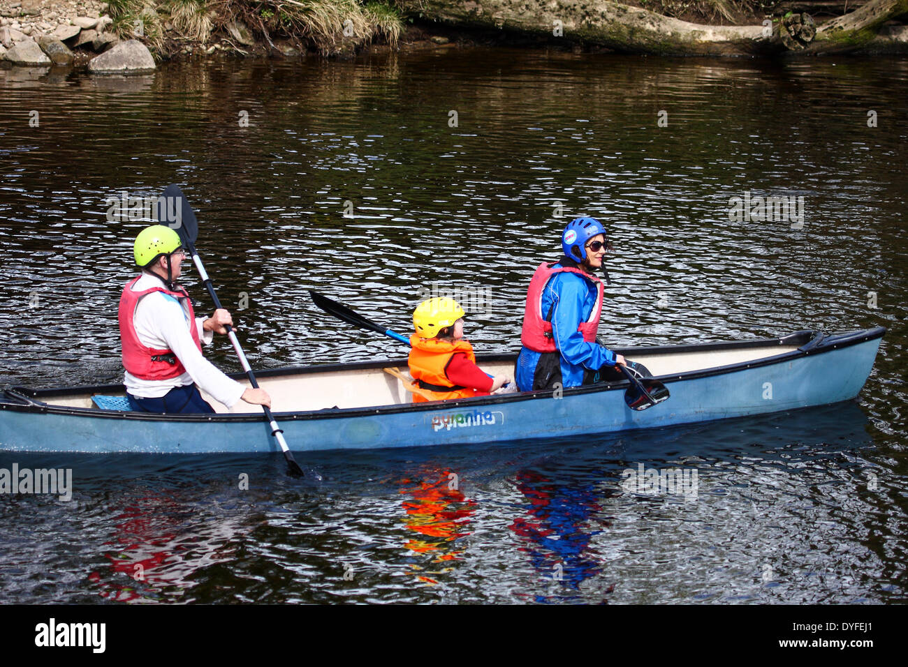 Family canoeing on river Wharf in Sping in Ilkley, West Yorkshire Stock ...