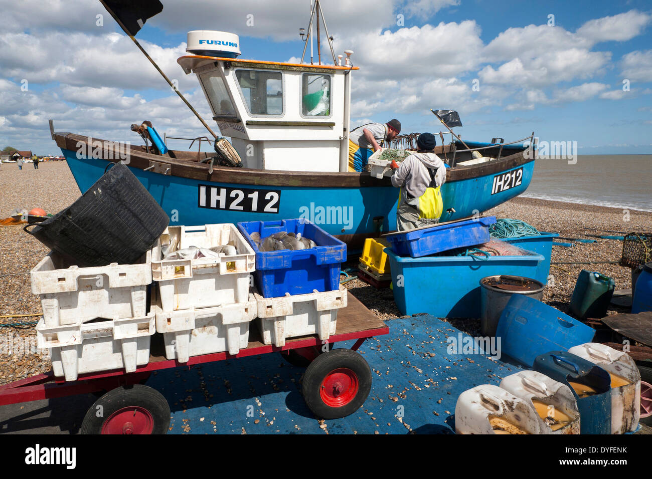 Small inshore fishing boat landing on the beach after six hours at sea ...