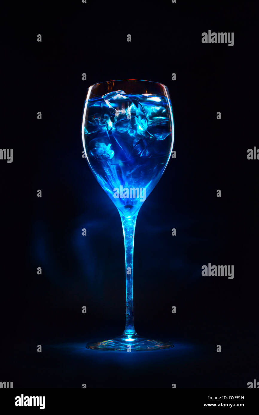 Amazing blue cocktail with ice cubes in high glass. Blue curacao liquor ...