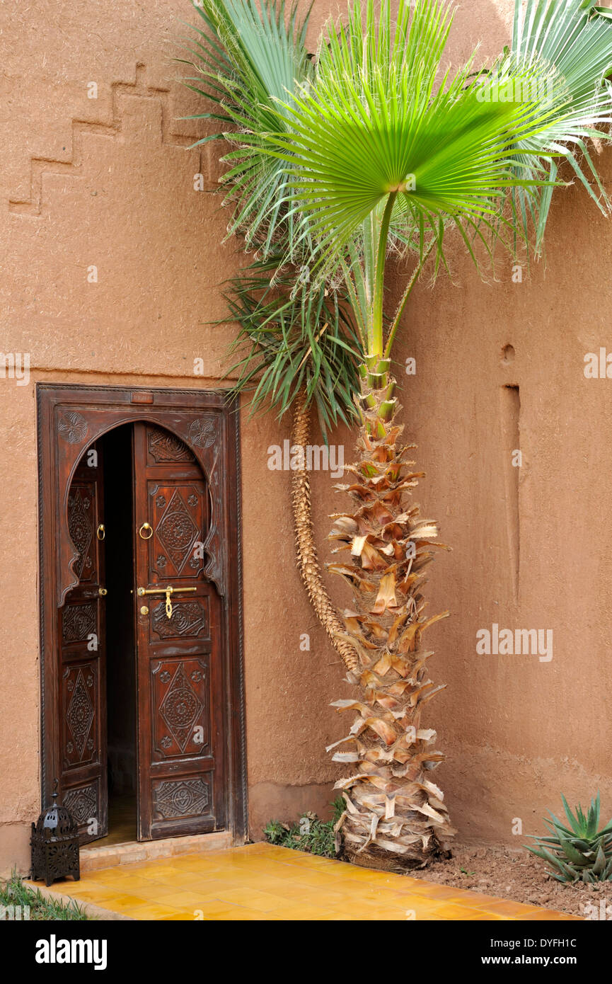 Muslim style wooden door open into dark room in adobe wall Stock Photo ...