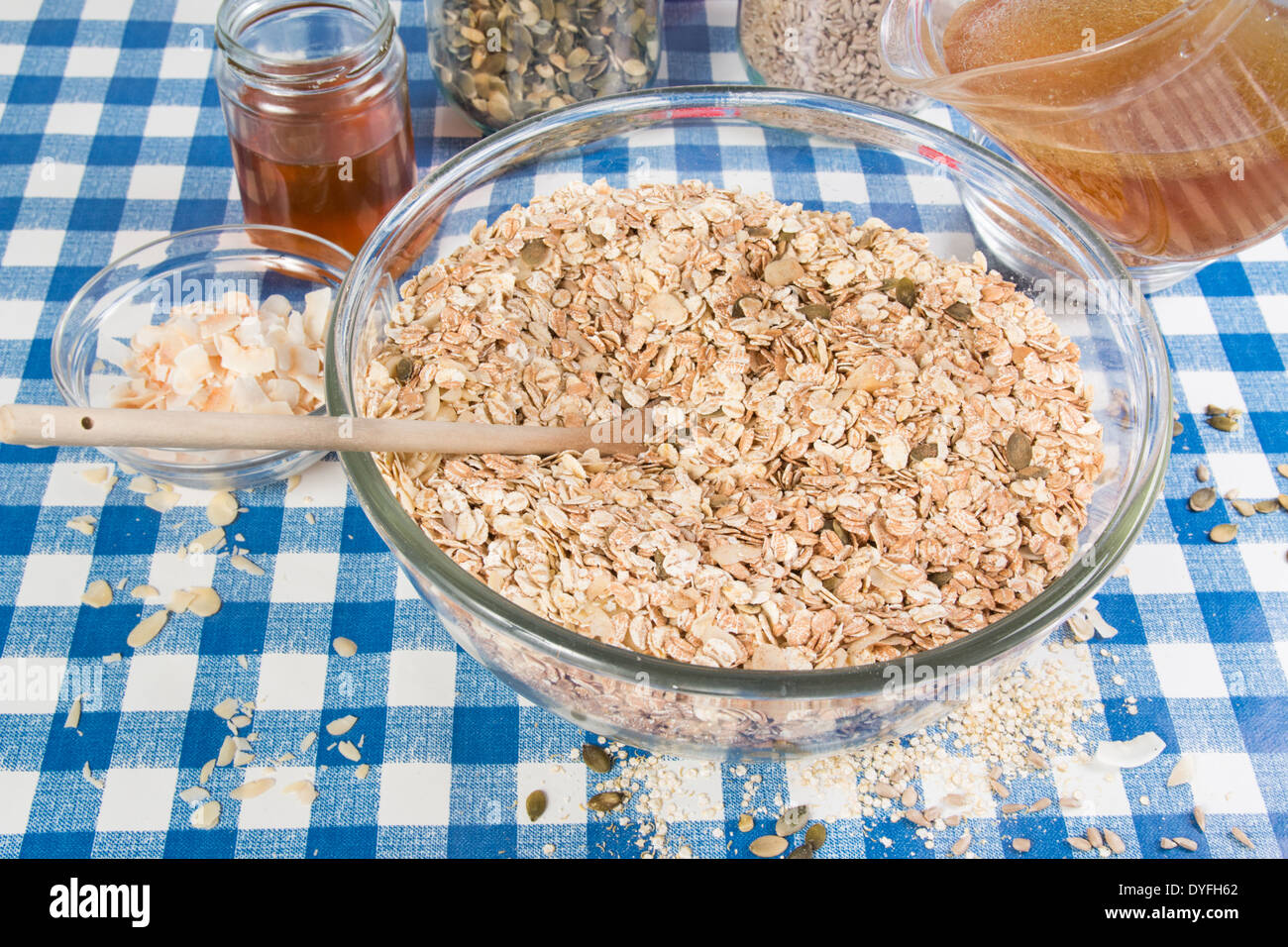 Making granola/muesli mixed cereals, seeds and nuts in a mixing bowl on ...
