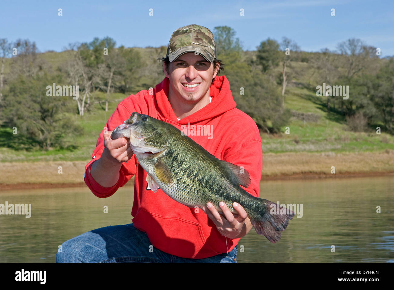 California fisherman holding a 6 pound largemouth bass caught at Lake ...