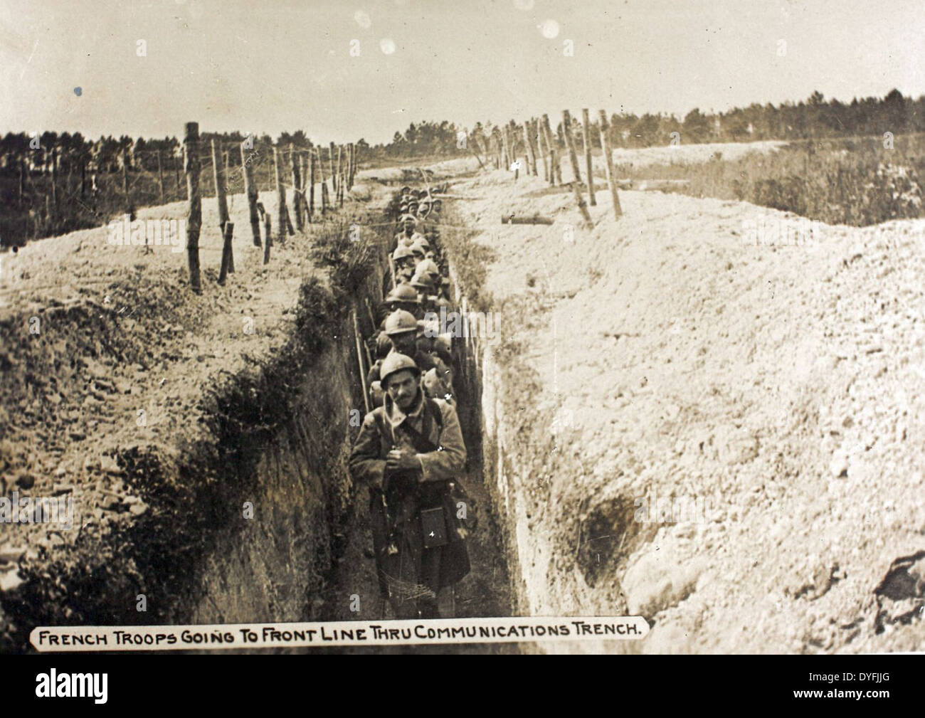 This image depicts French troops moving through a communication trench ...