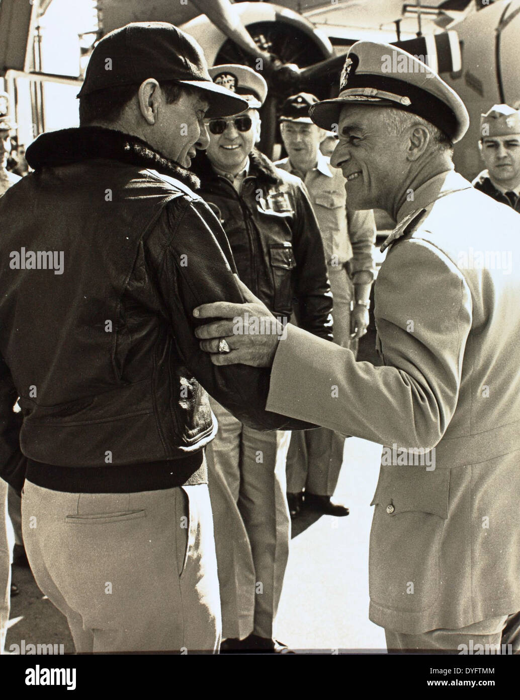 Rear Admiral Karaberis is pictured welcoming a pilot, captured in this ...