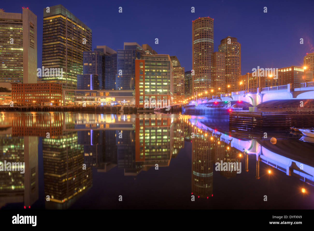 The skyline and Evelyn Moakley Bridge reflect off Fort Point Channel in ...