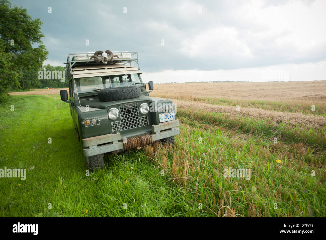 Land Rover parked next to harvested wheat field Stock Photo - Alamy