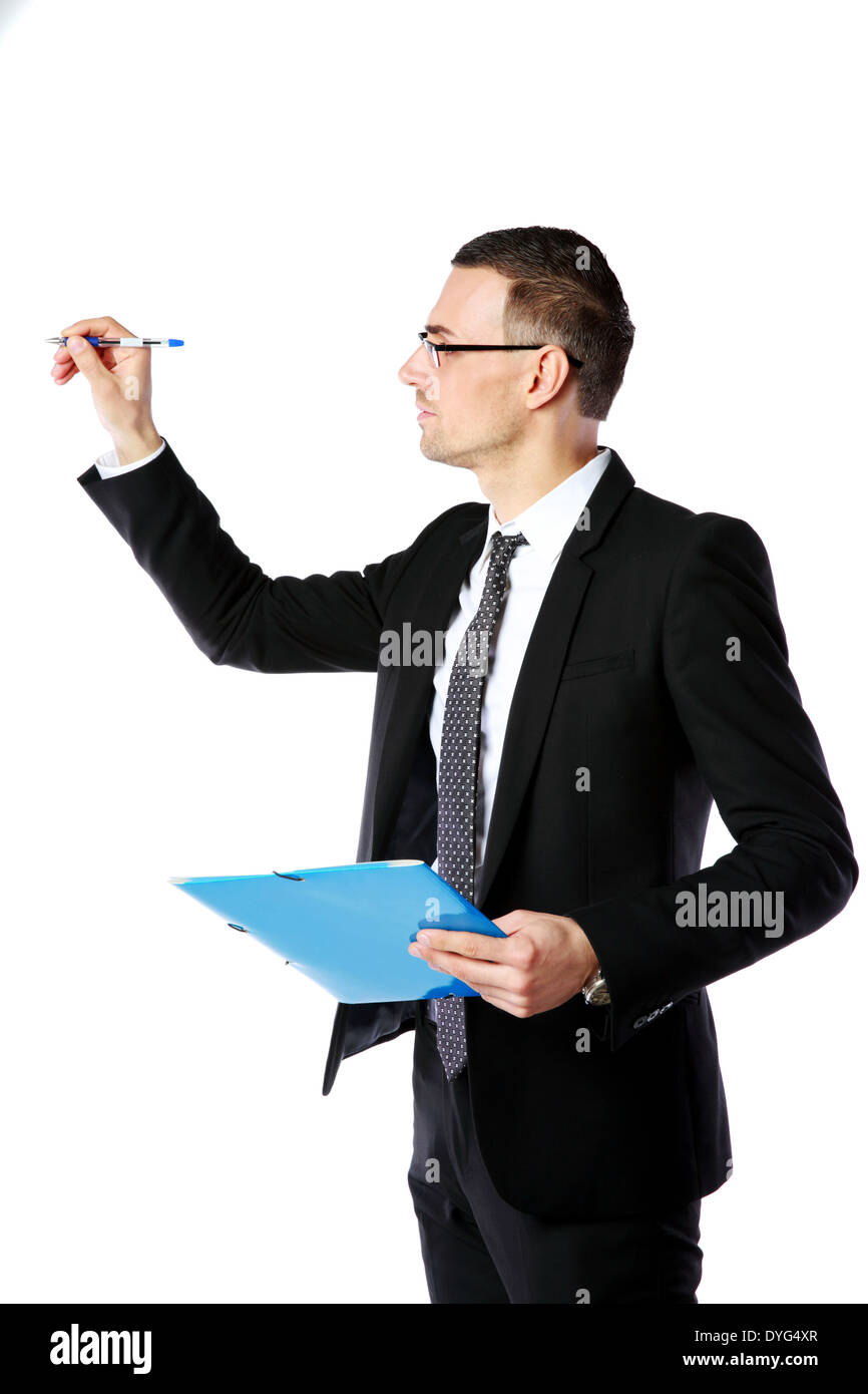 Handsome businessman writes with pen at copyspace over white background ...