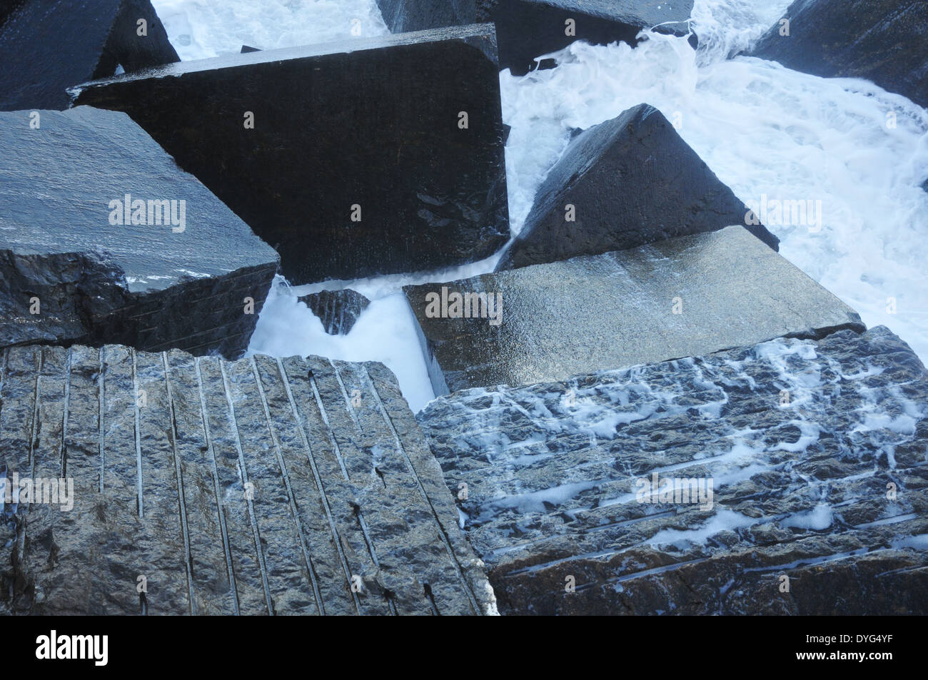 waves crash over stone boulders Stock Photo - Alamy
