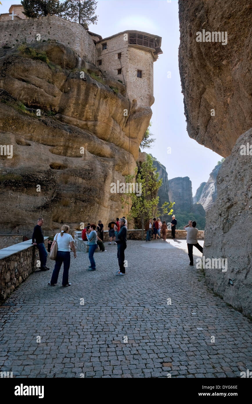 Meteora monasteries on the rocks, tourists admire architecture, Greek ...