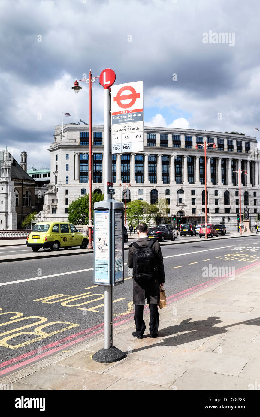A commuter waiting at a bus stop Stock Photo - Alamy