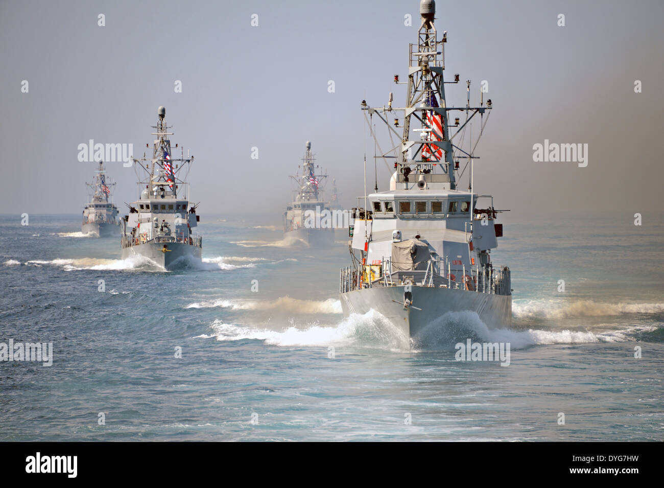 US Navy coastal patrol ship the USS Firebolt leads a formation of other ...