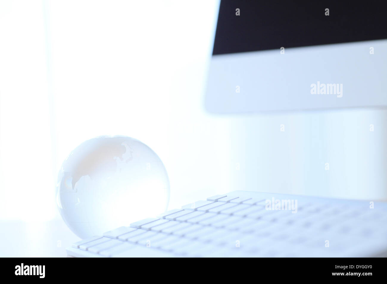 Glass globe and computer Stock Photo - Alamy