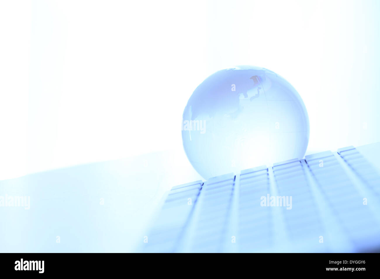 Glass globe and computer Stock Photo - Alamy