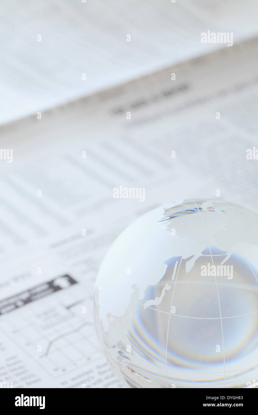 Glass globe and newspaper Stock Photo - Alamy