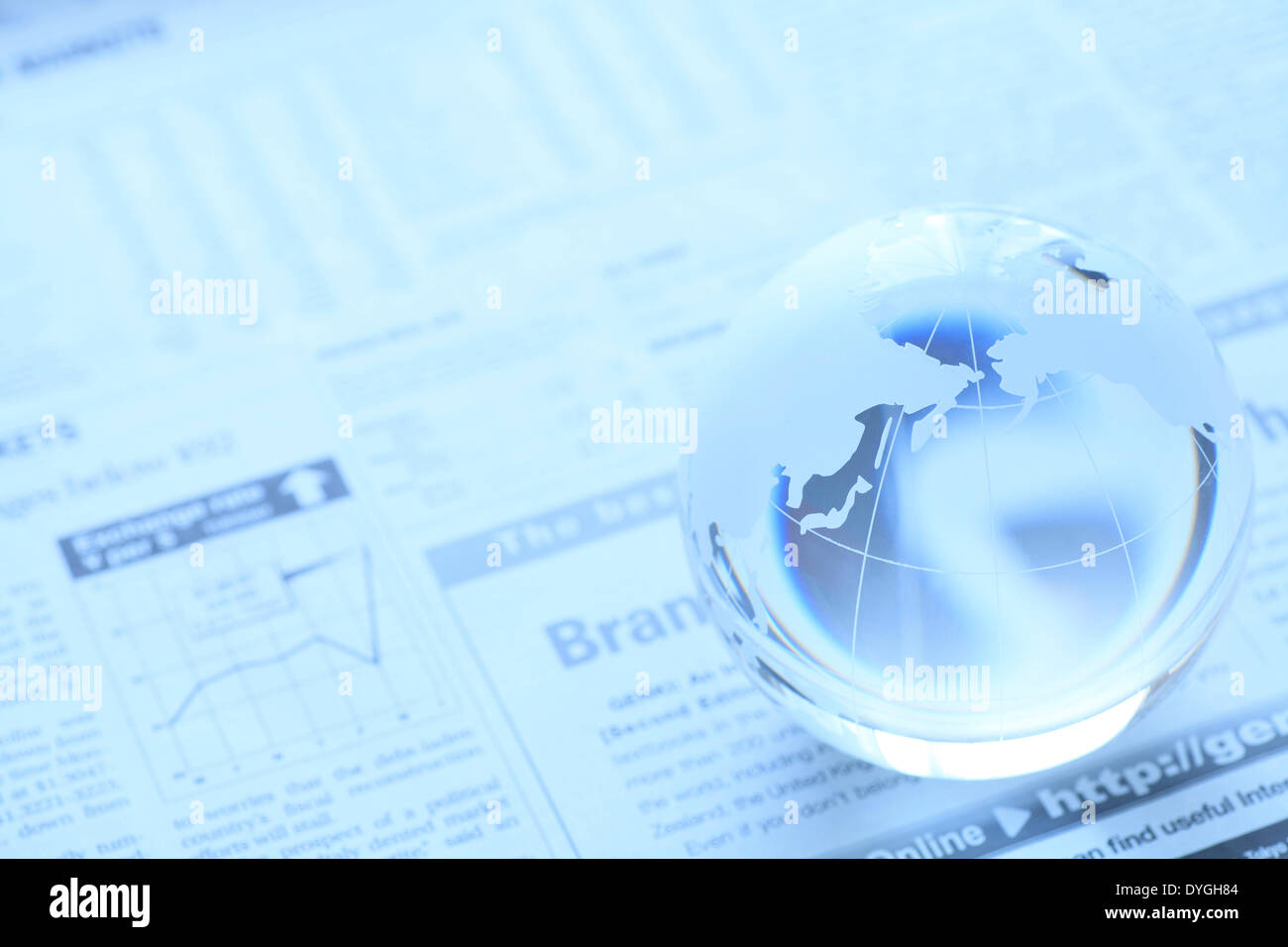Glass globe and newspaper Stock Photo - Alamy