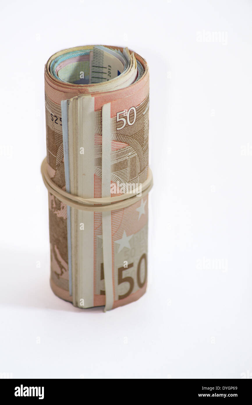 Rolled up money using rubber band Stock Photo - Alamy