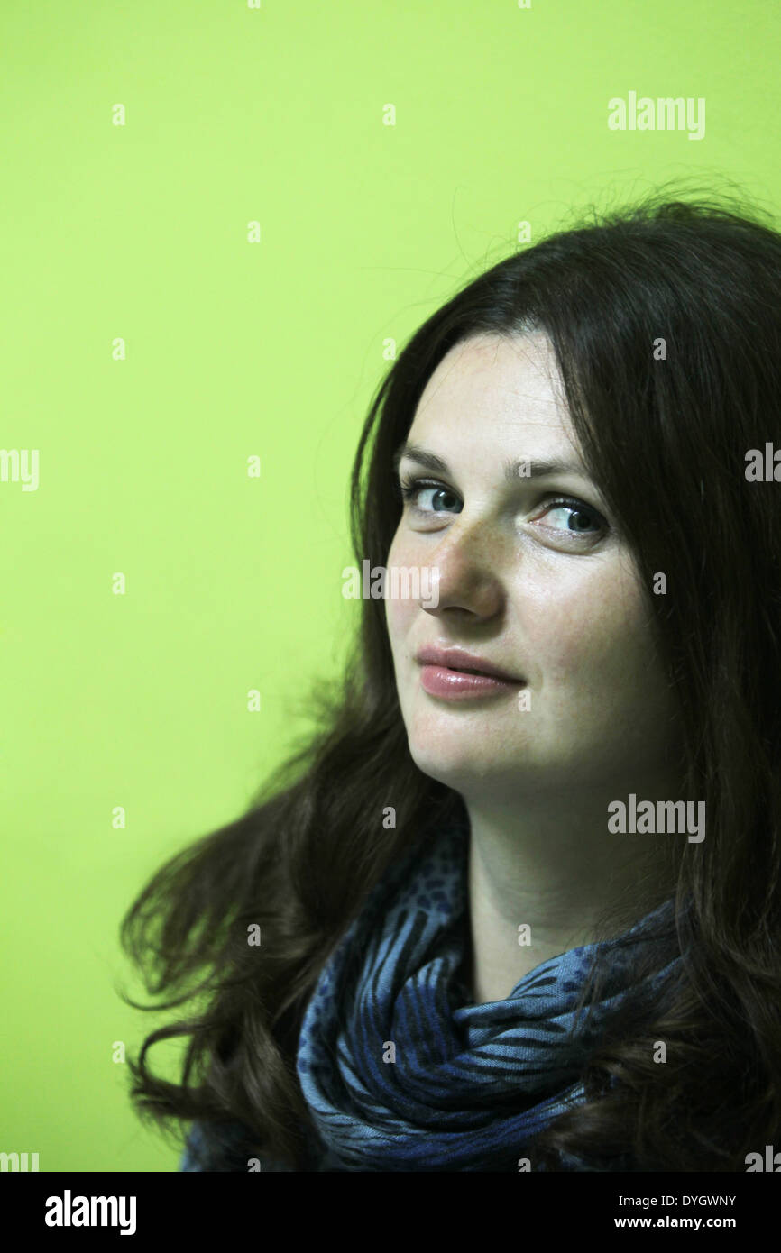 Portrait of a young woman with green background Stock Photo - Alamy