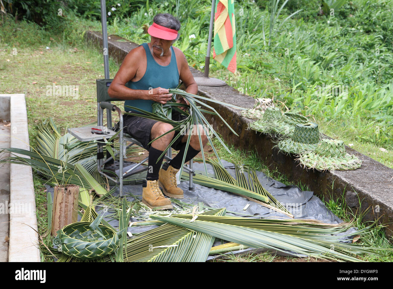 Local Hawaiian weaving palm leaves at 6 am next to one of the most ...