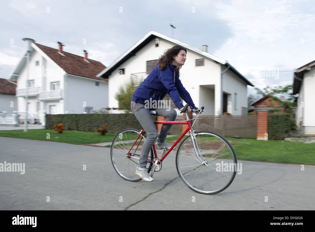 A young woman driving a bicycle in the street Stock Photo - Alamy