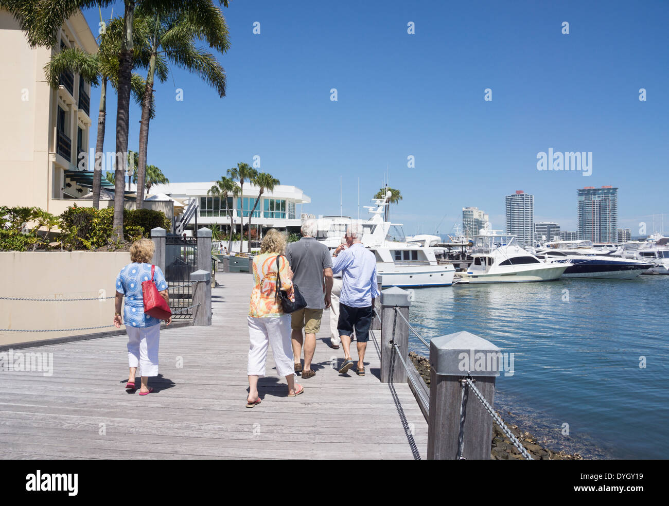 Group of tourists walk around the marina on the Spit at Surfers ...