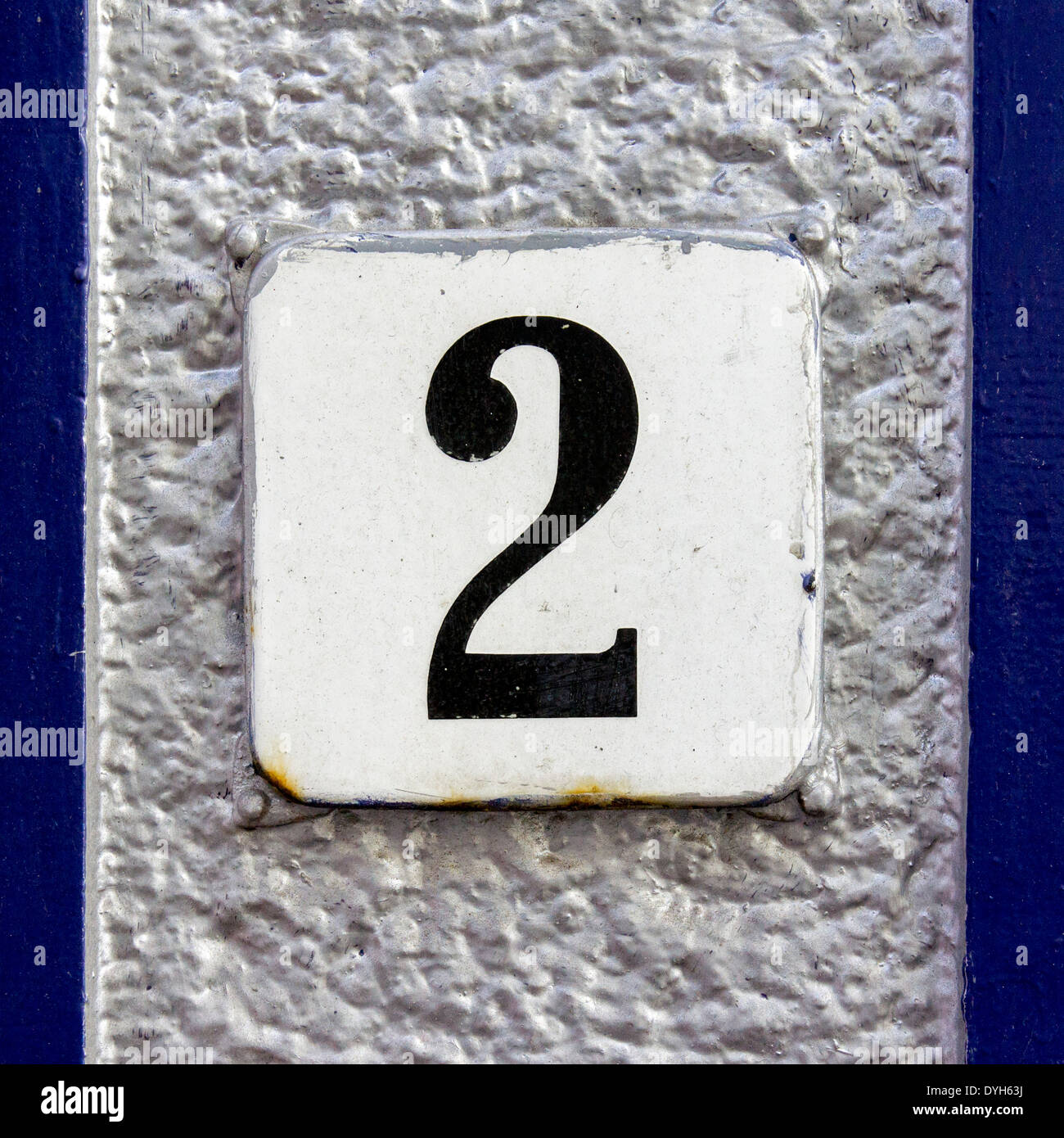 House number two on an enameled plate. Black lettering on a white ...