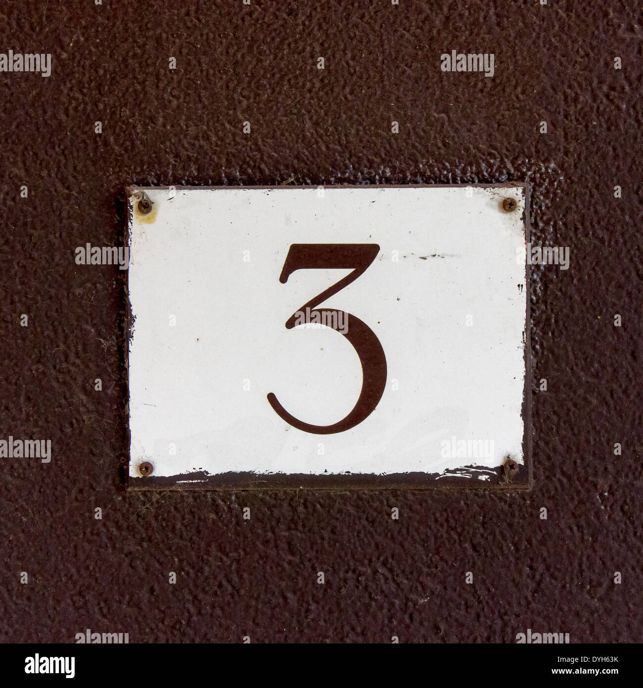 house number three. Brown lettering on a white plastic plate Stock ...