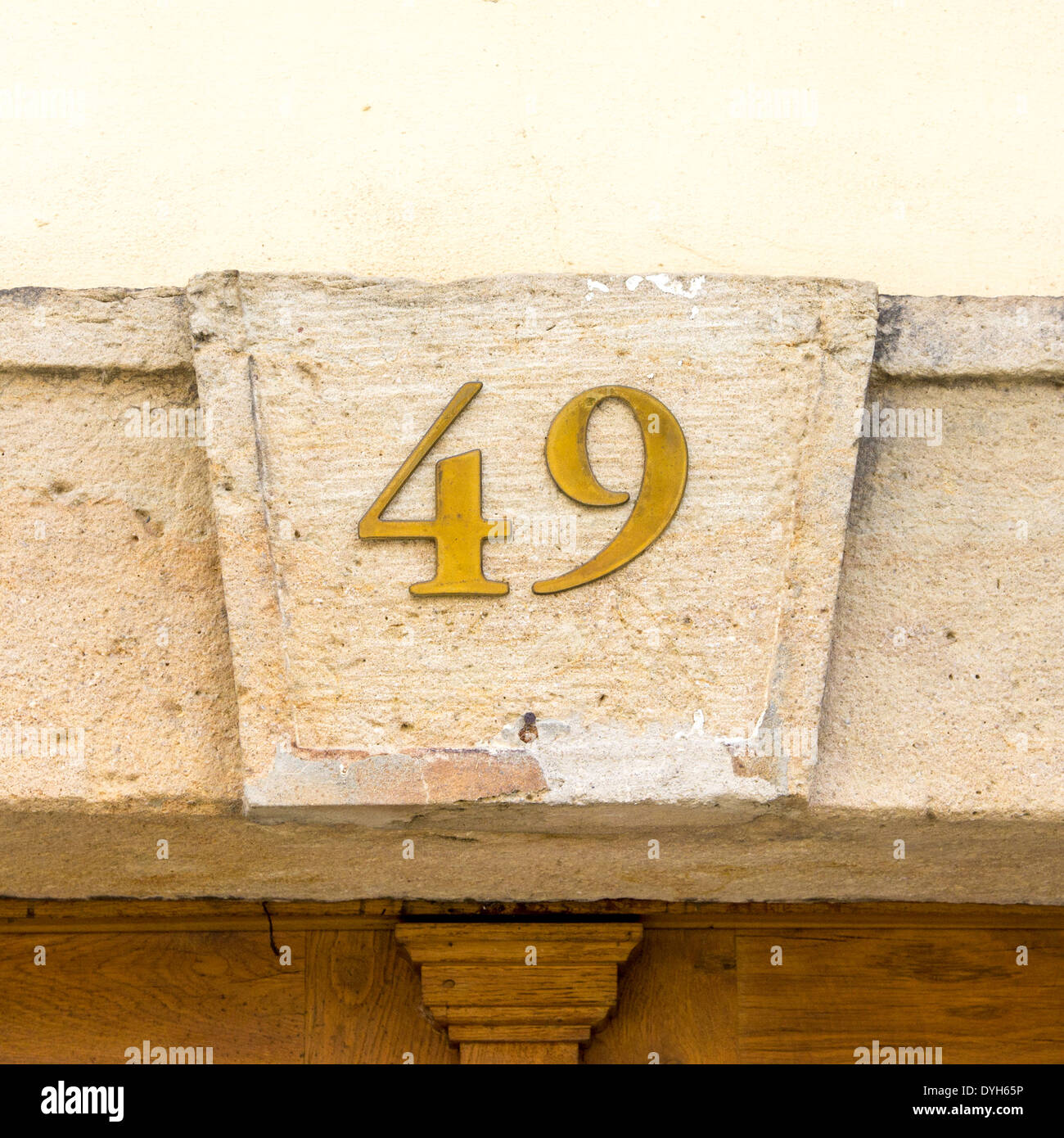 House number forty nine. Brass numerals on a plastered background Stock ...