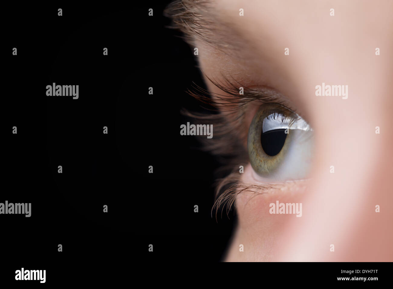 female teen green eye from side over black background Stock Photo - Alamy