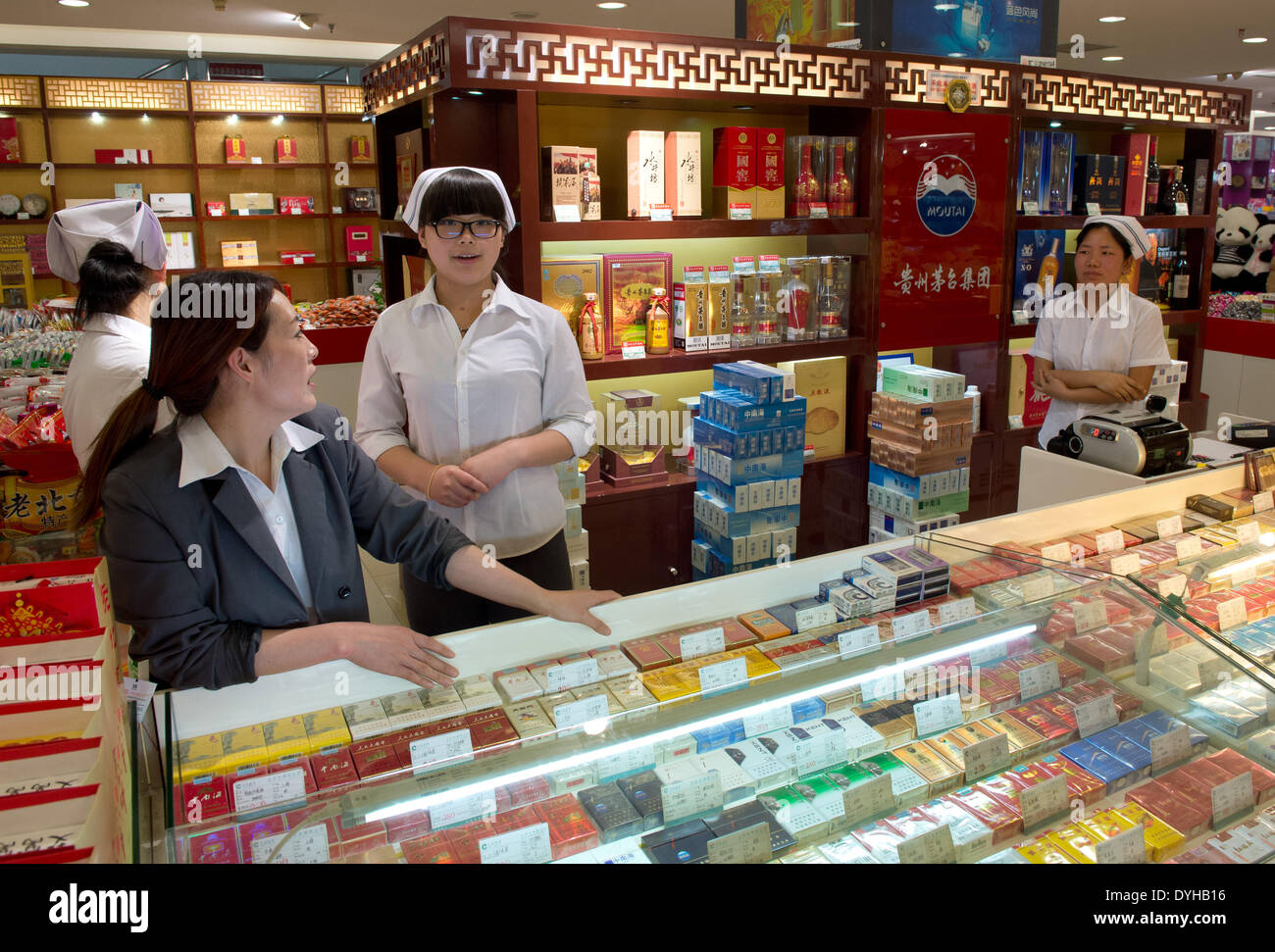 Beijing, China. 14th Apr, 2014. Women sell cigarettes behind a counter ...