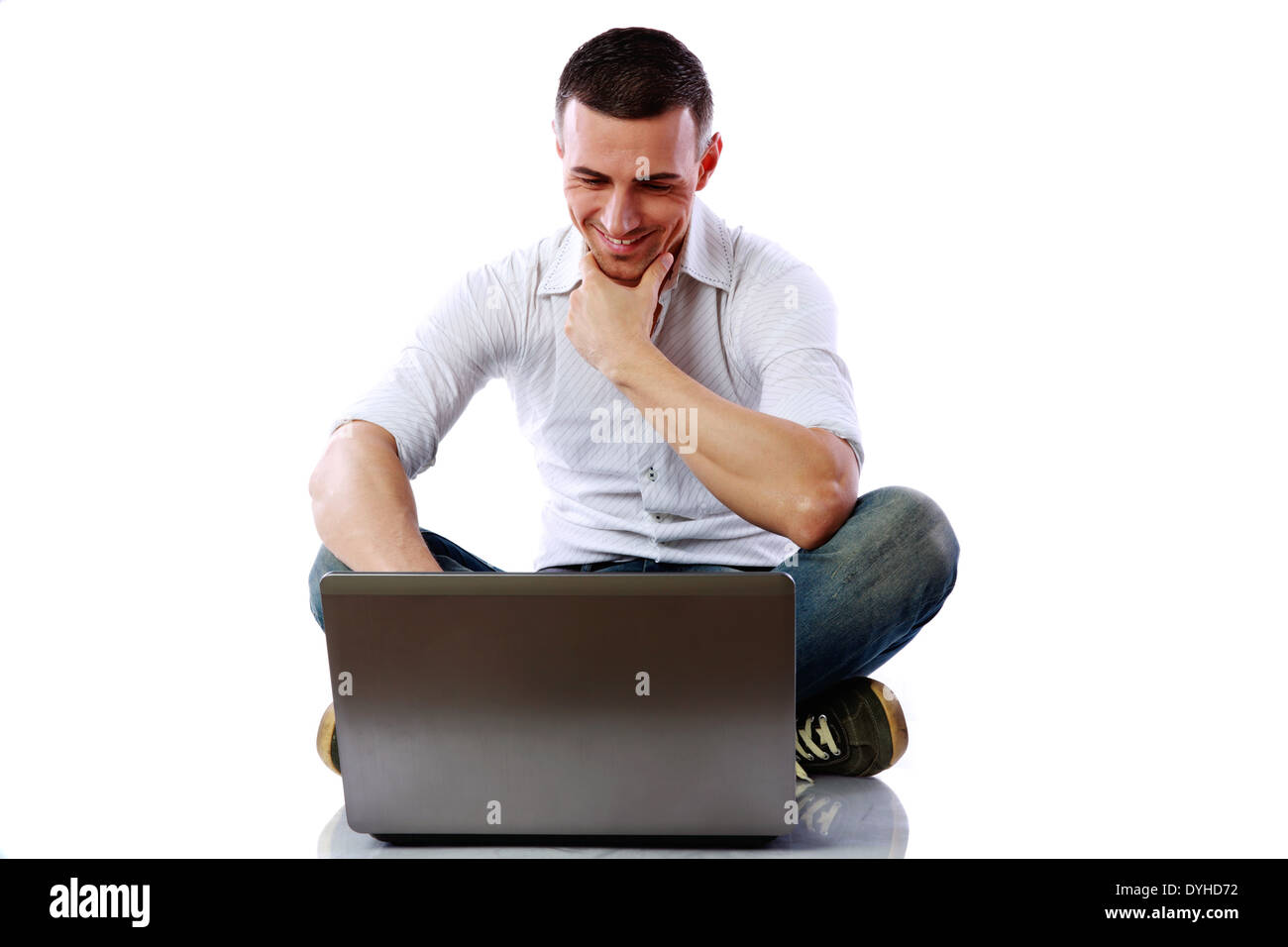 Happy man sitting at the floor with laptop over white background Stock ...