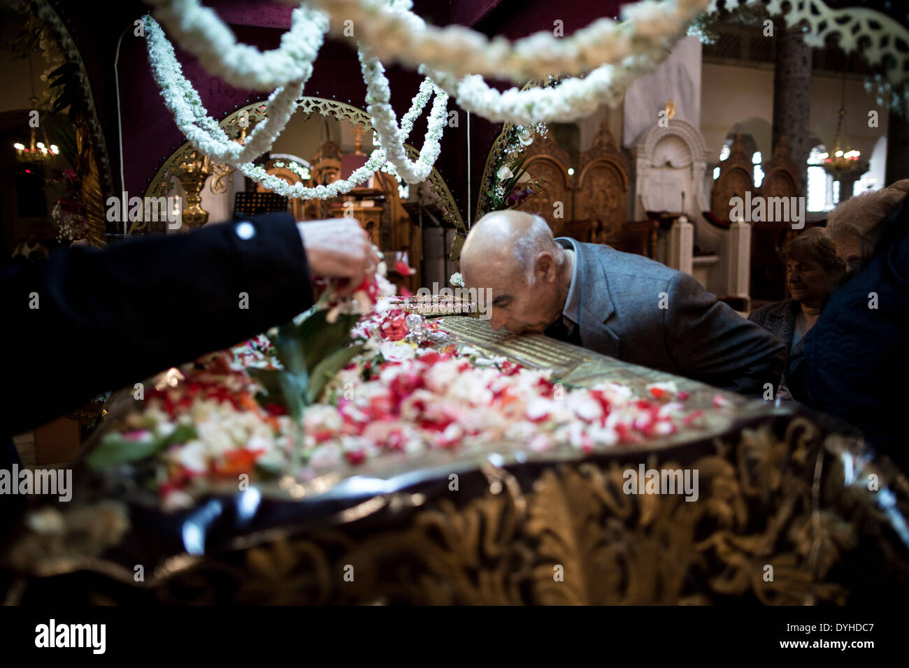 Thessaloniki, Greece. 18th April 2014. A worshiper touches a bible ...