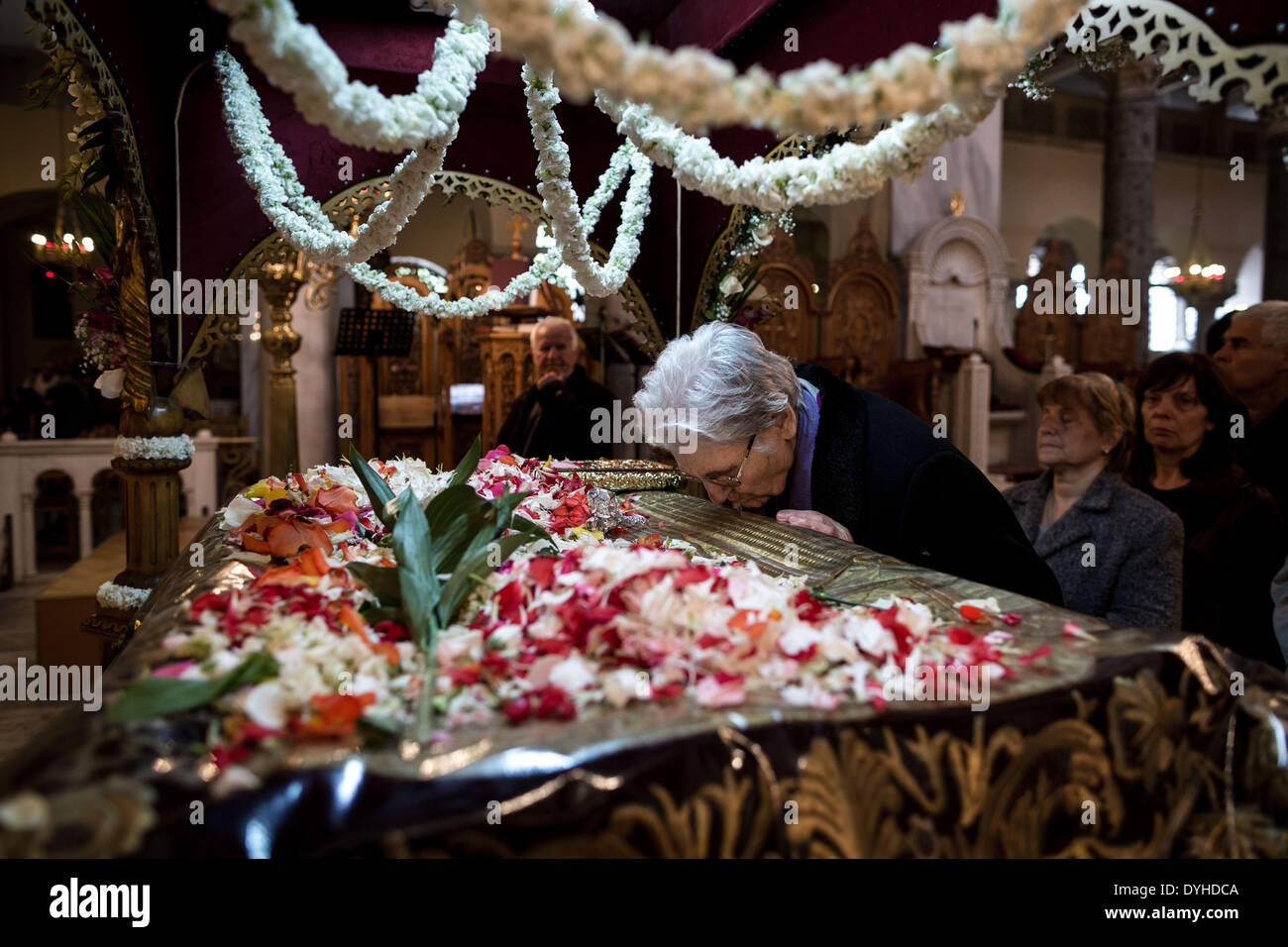 Thessaloniki, Greece. 18th April 2014. A worshiper touches a bible ...