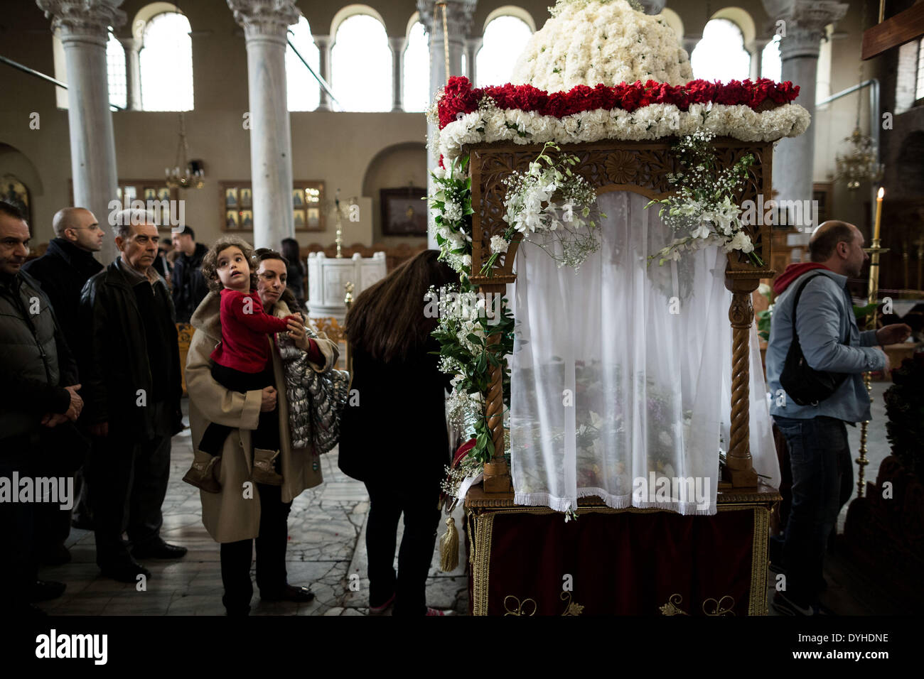 Thessaloniki, Greece. 18th April 2014. A worshiper touches a bible ...