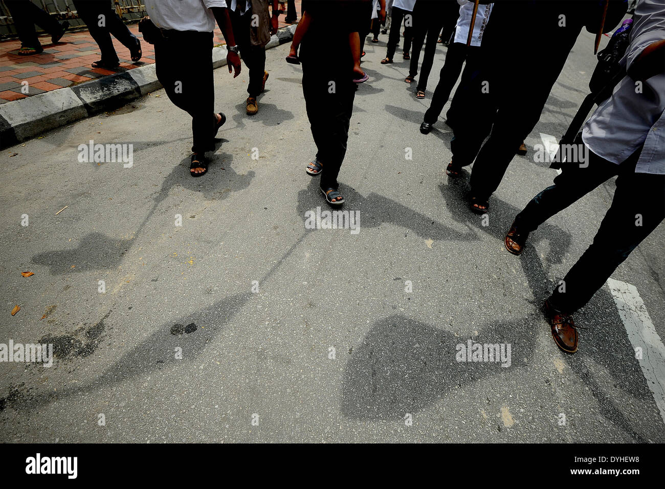 Kuala Lumpur, Malaysia. 18th Apr, 2014. Shadows of protesters are cast ...