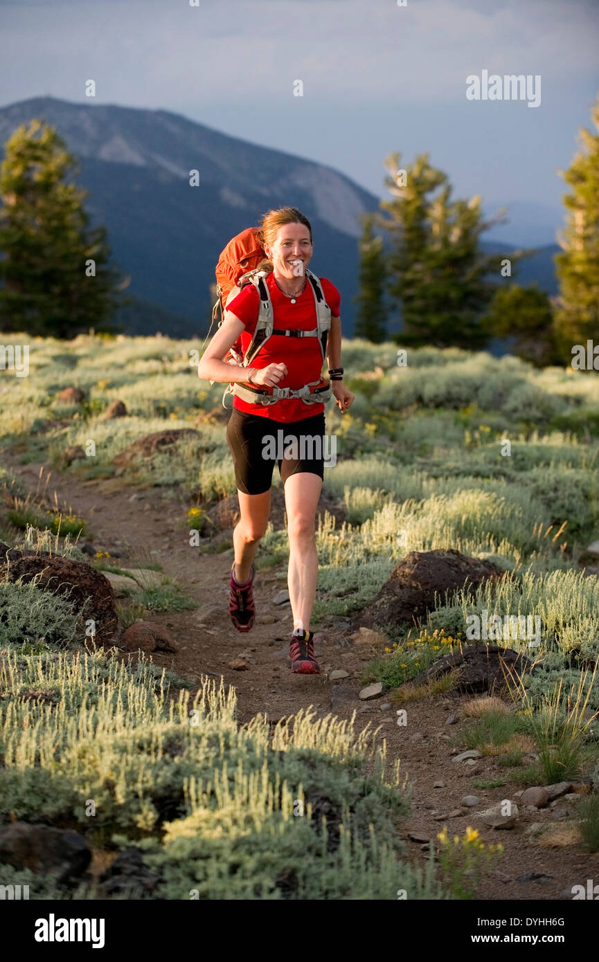 A woman, endurance athlete, fastpacking on the Tahoe Rim Trail Stock ...