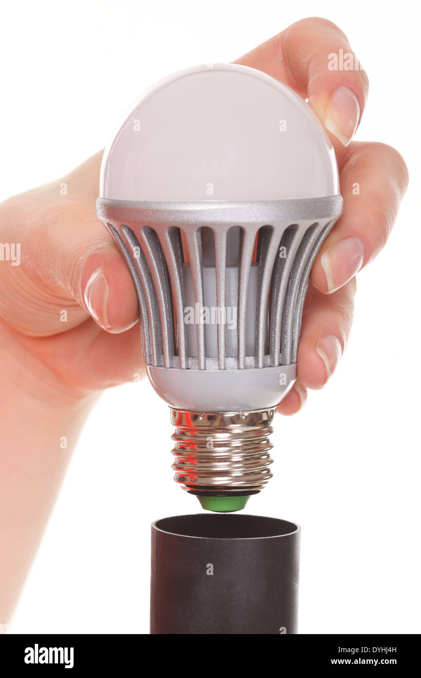Screw bulb into a cap on white background Stock Photo - Alamy