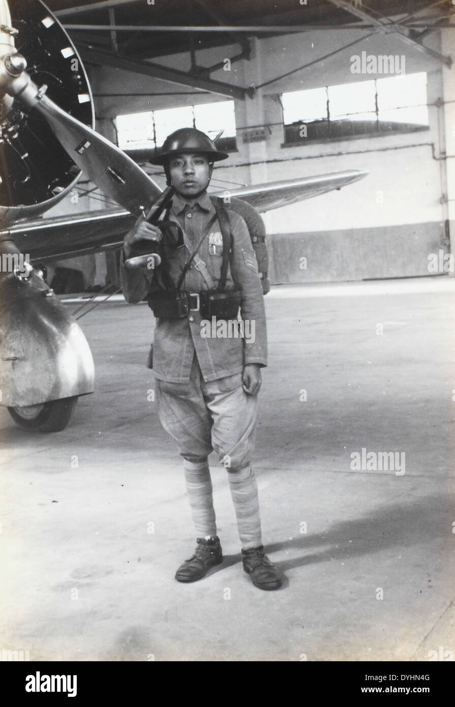 This photo depicts a soldier in a factory during World War II. The ...