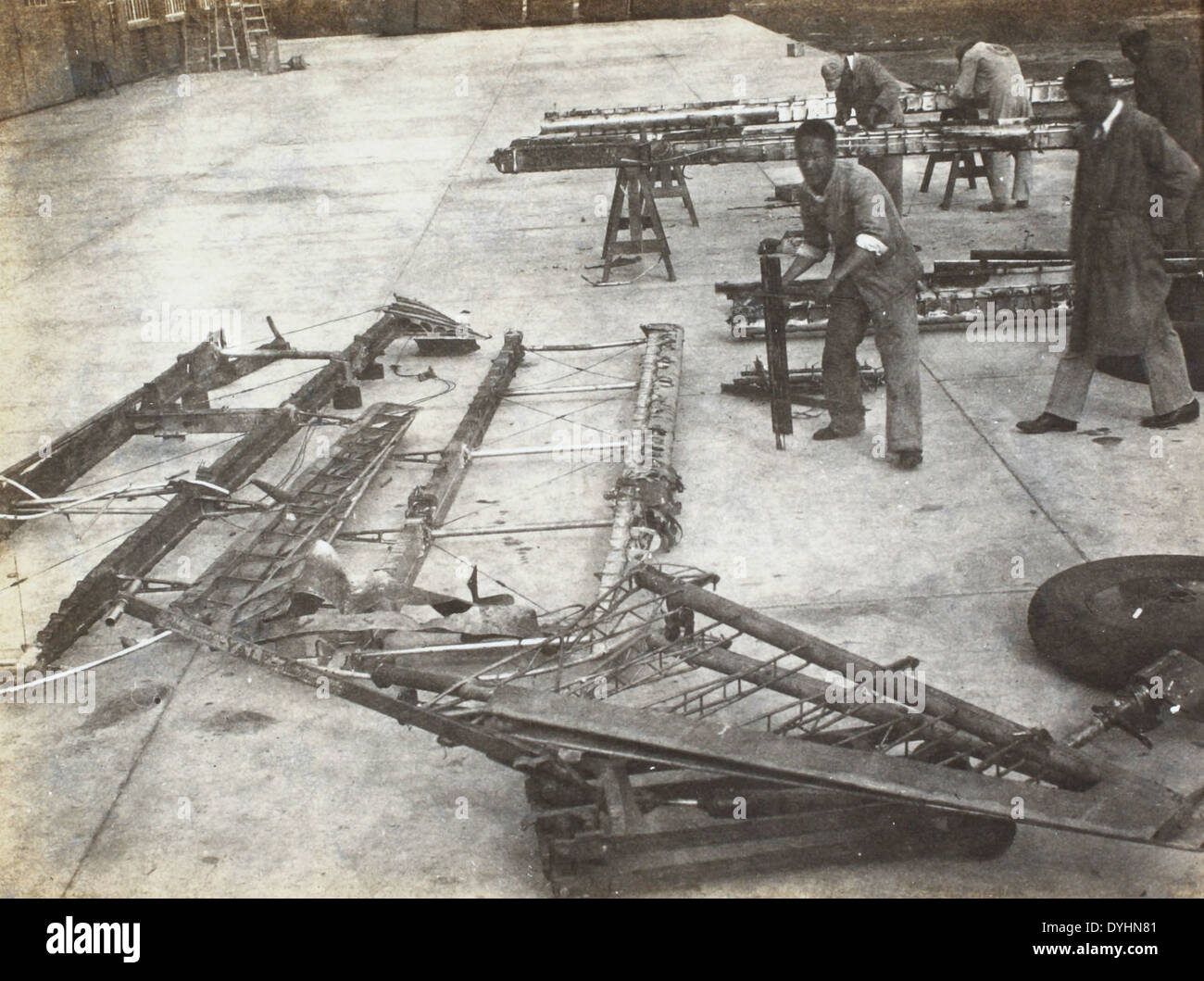 This photograph showcases workers engaged in the construction of an ...